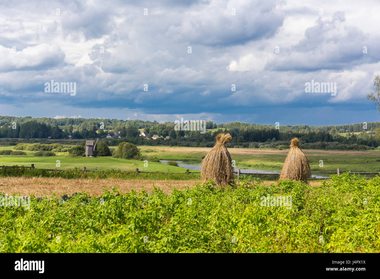 Rural landscape with haystack in the garden Stock Photo - Alamy