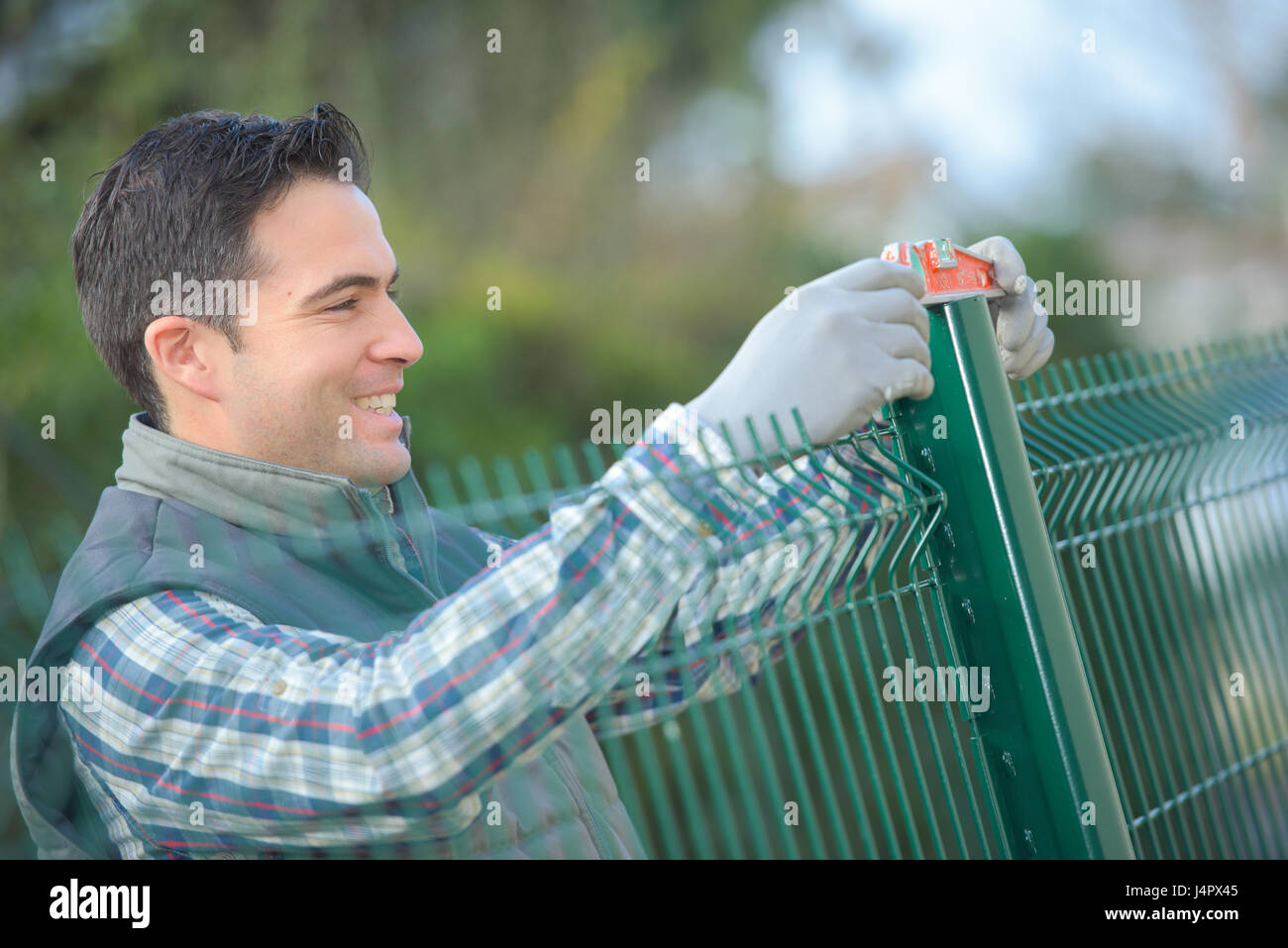 the fence worker Stock Photo - Alamy