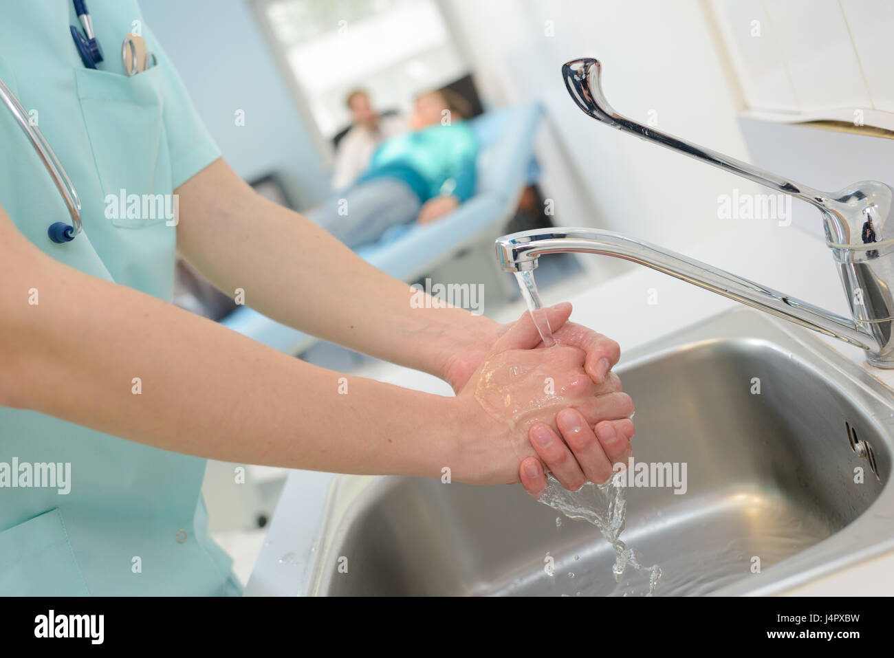 Nurse washing hands with tap hi-res stock photography and images - Alamy