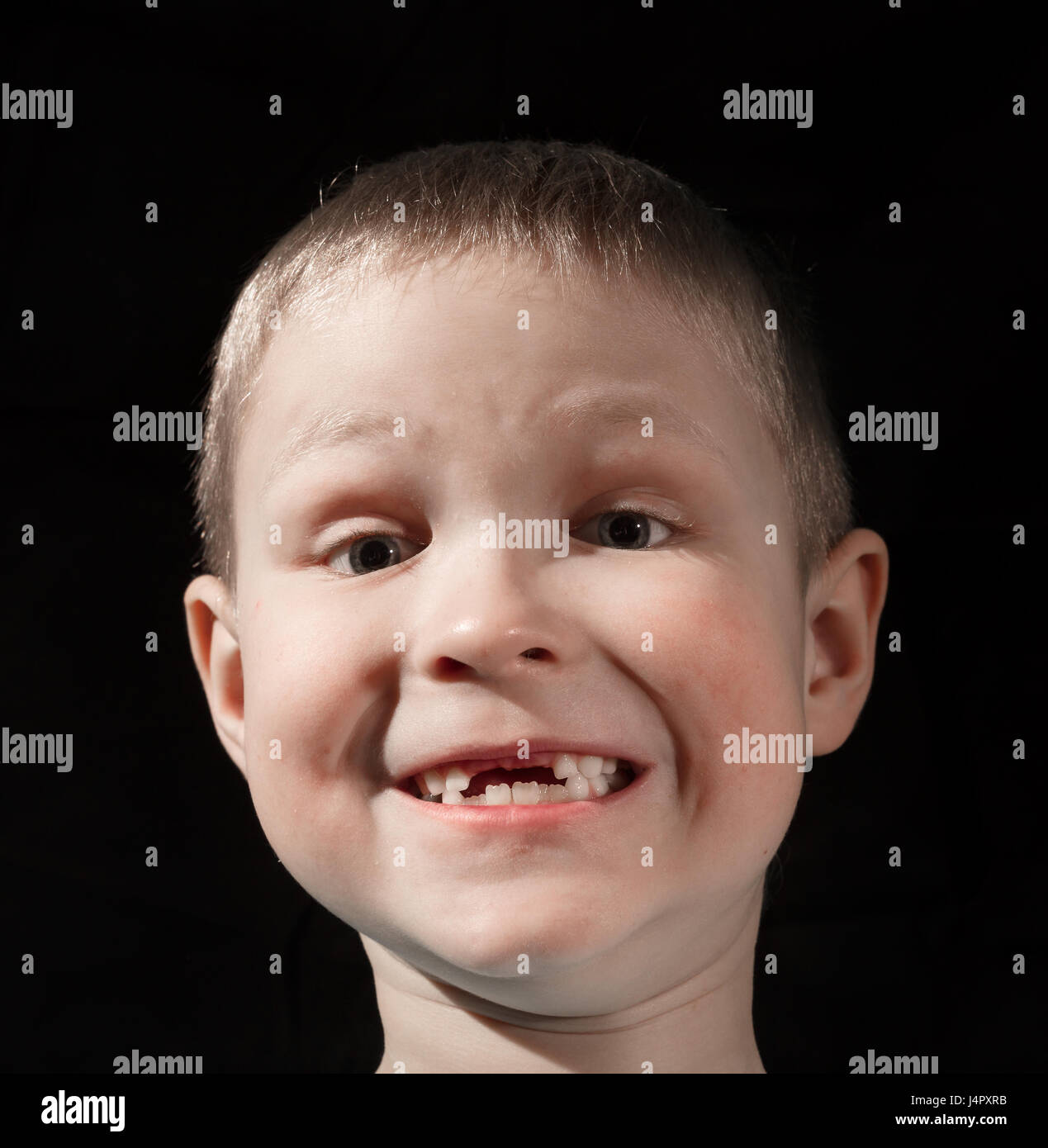 Cute boy missing some front teeth smiling Stock Photo - Alamy