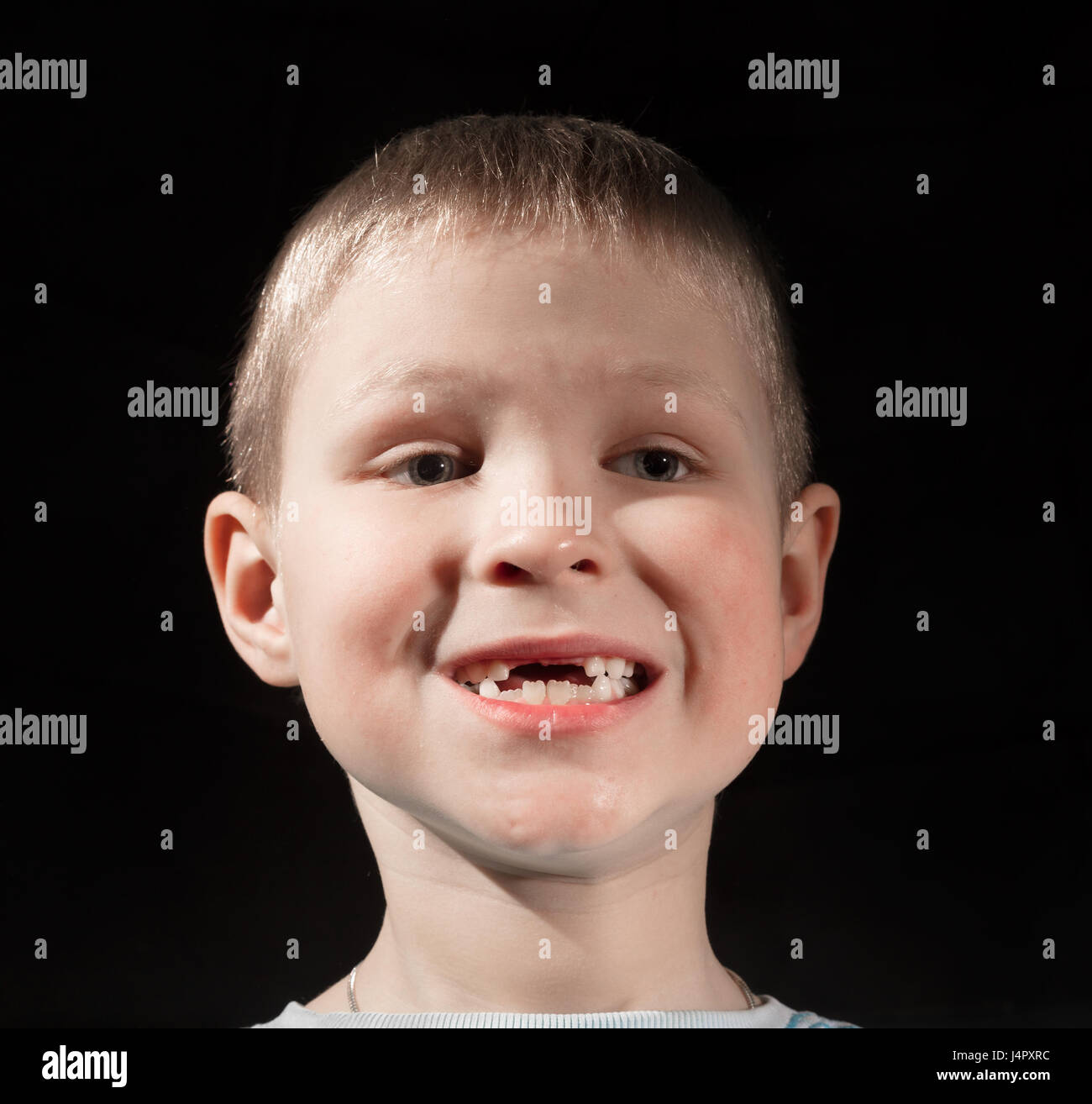 Cute boy missing some front teeth smiling Stock Photo - Alamy
