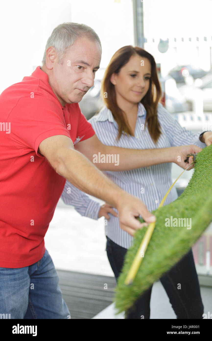 man and woman measuring something Stock Photo - Alamy