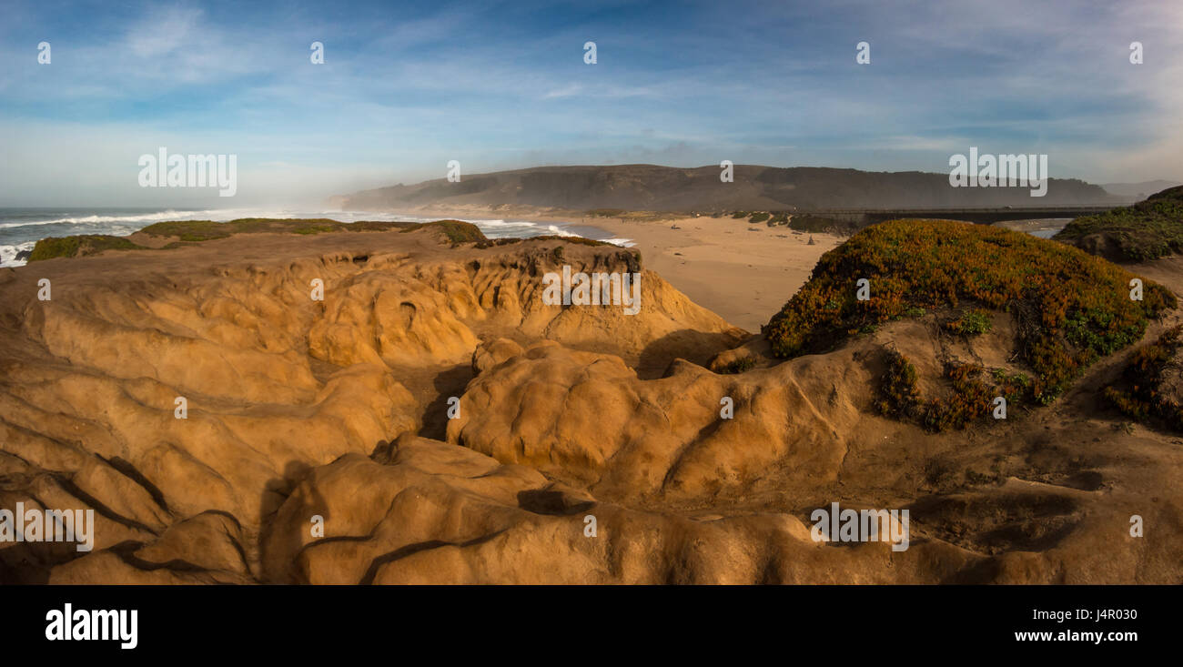 Looking at a Beach from smooth rock formation Stock Photo - Alamy