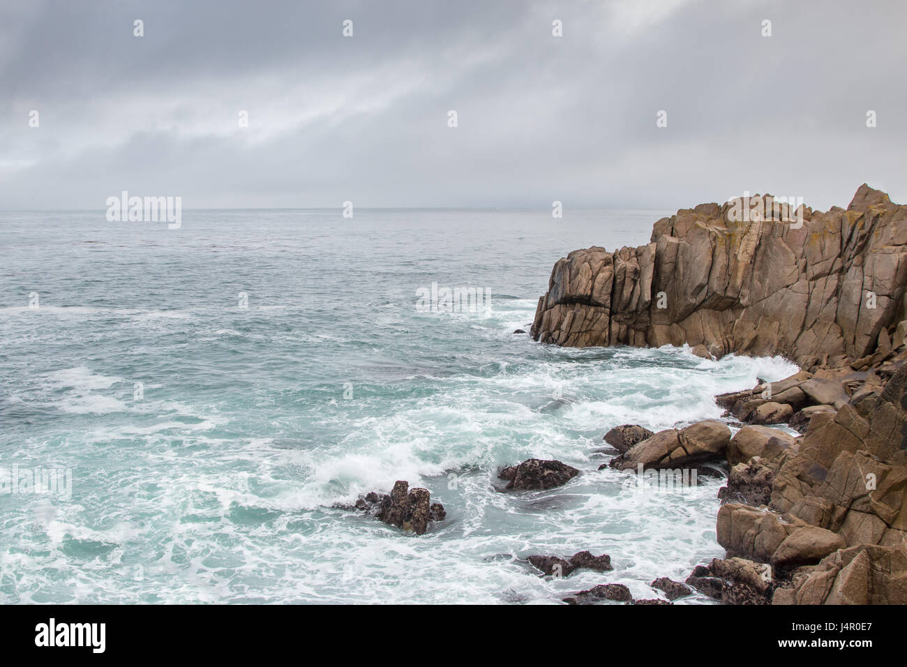 Ocean Waves crashing against Rock Cliff Stock Photo - Alamy