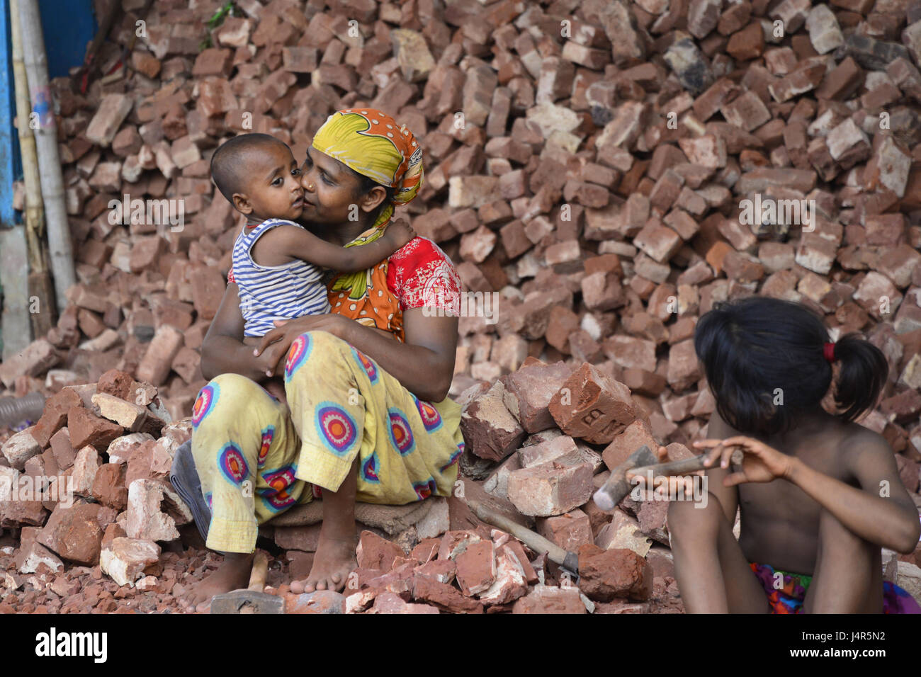 Dhaka, Bangladesh. 13th May, 2017. A worker mothers kisses her child at ...
