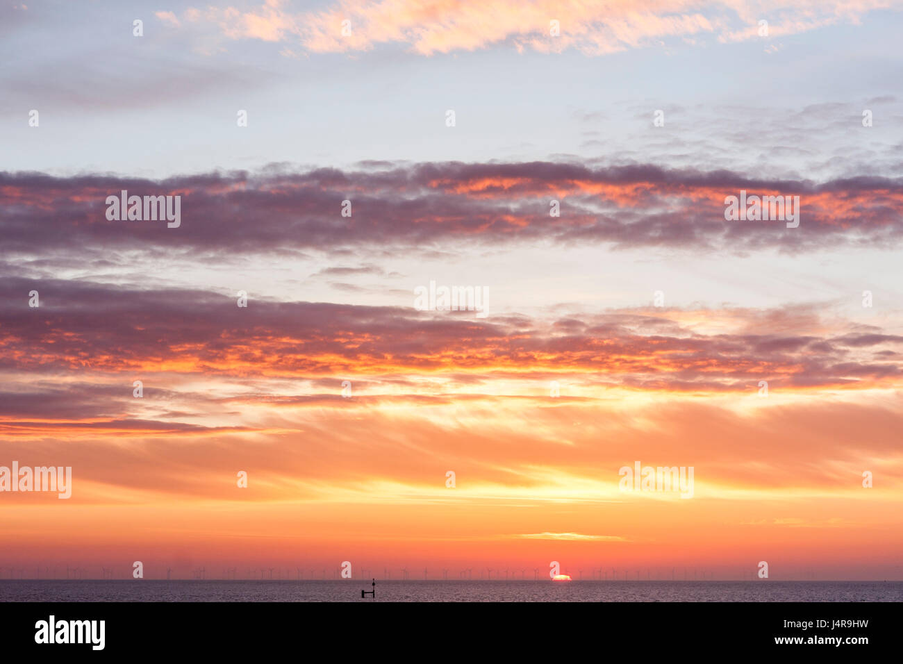 England, Ramsgate. Sunrise and dawn sky over the Thanet offshore wind ...