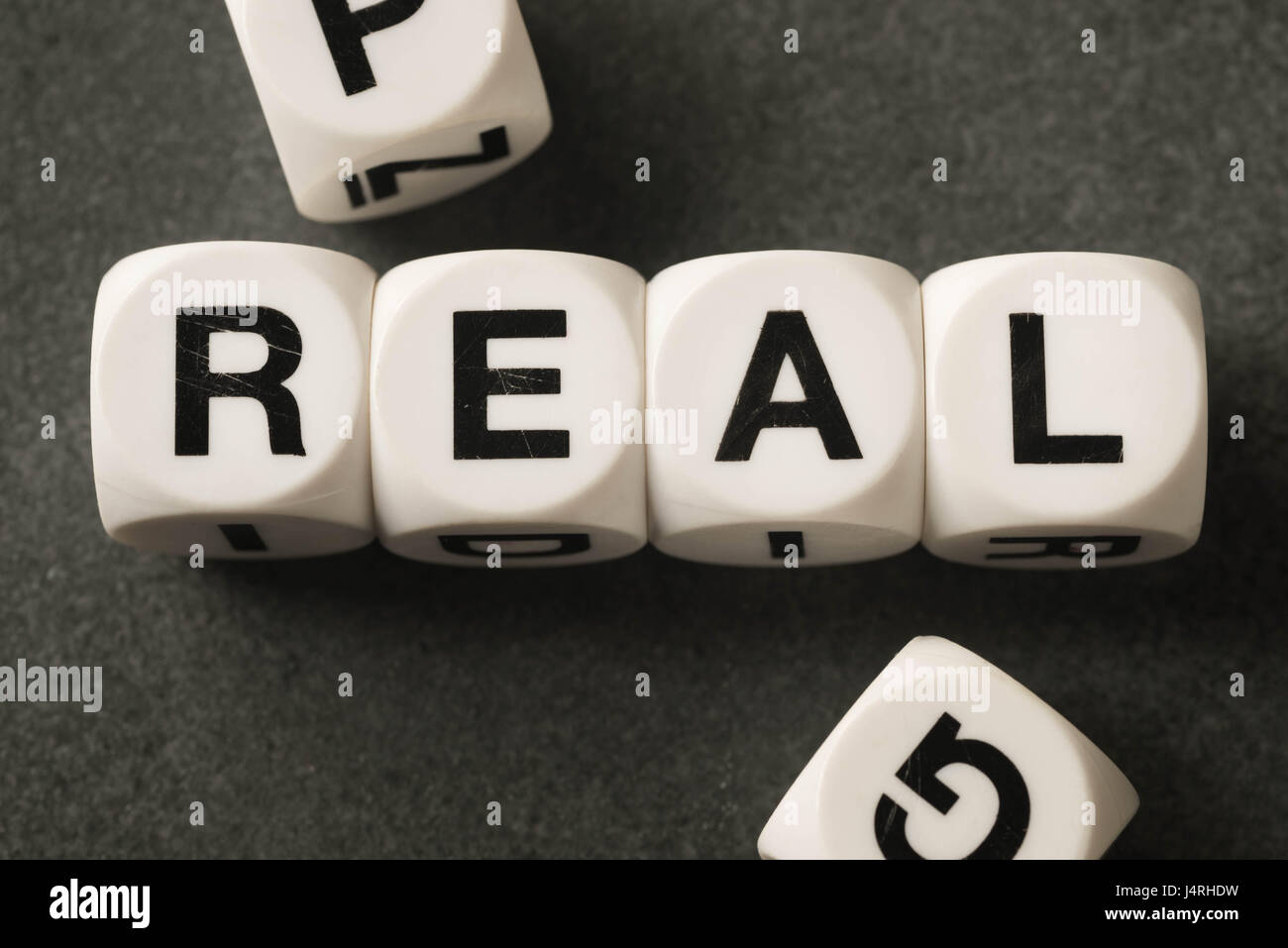 word real on white toy cubes Stock Photo - Alamy