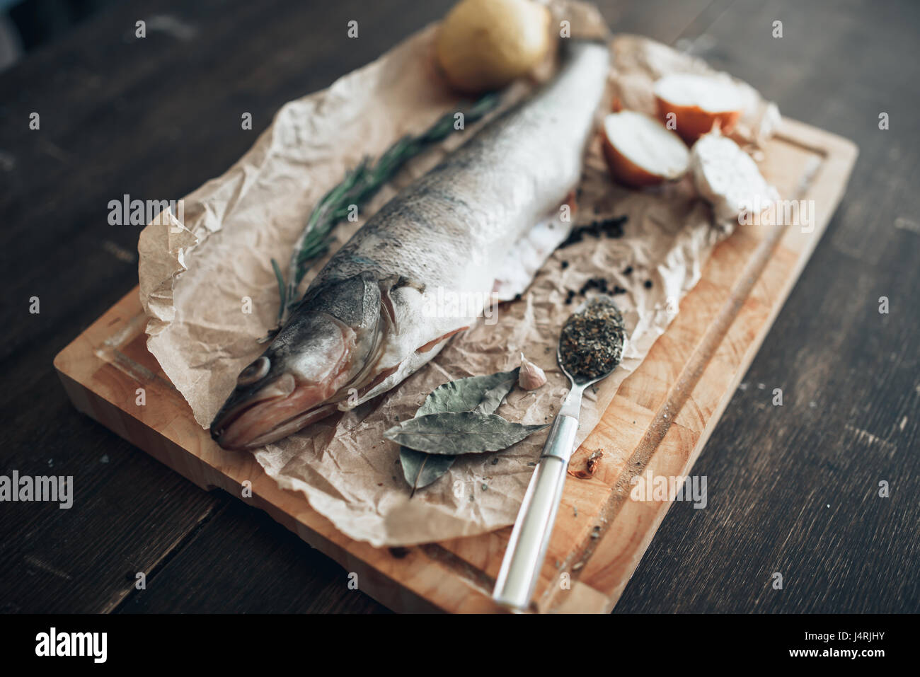 Fresh fish preparation ingredients, herbs, spices, onion and garlic ...