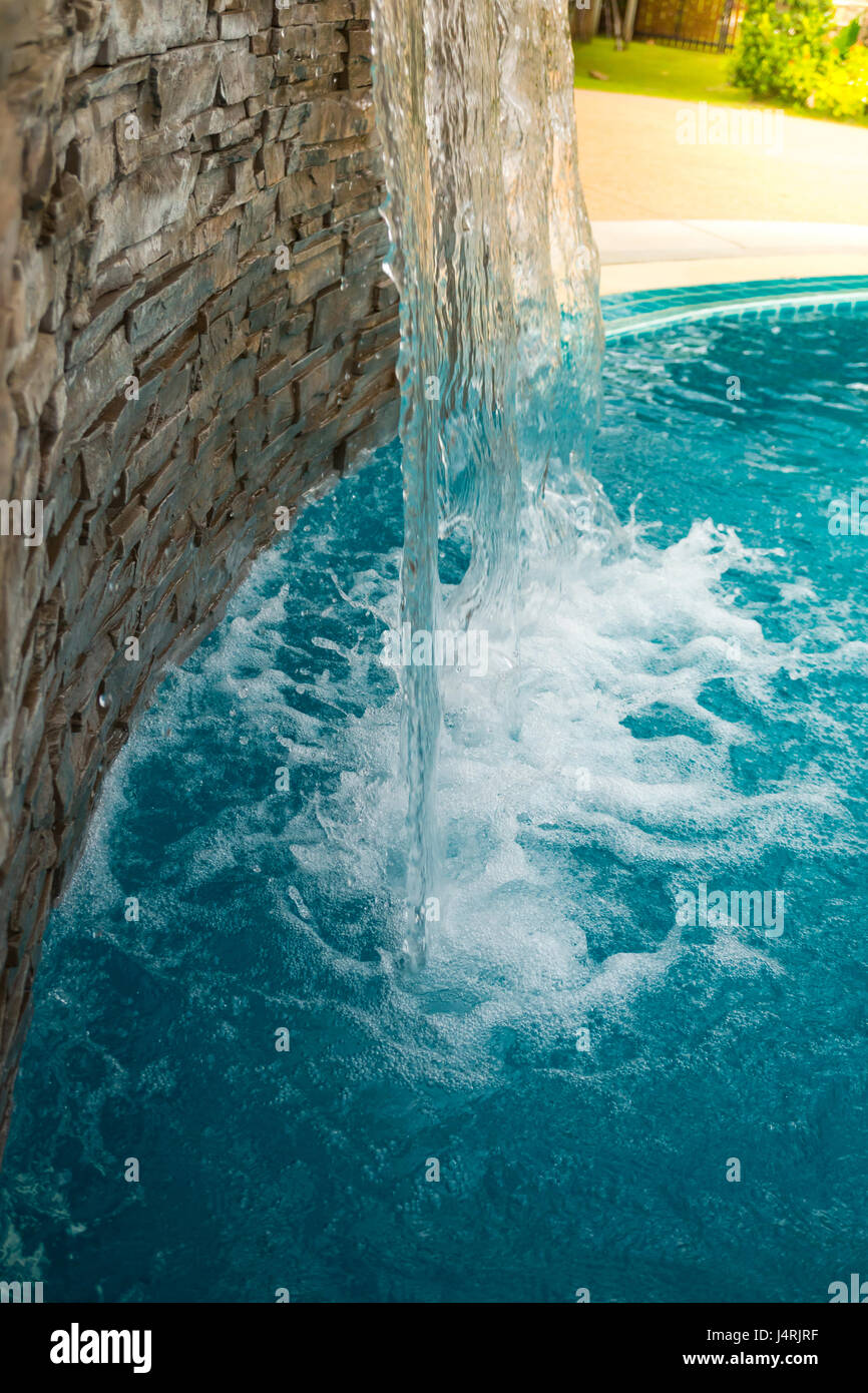 Small artificial waterfall in the swimming pool Stock Photo - Alamy