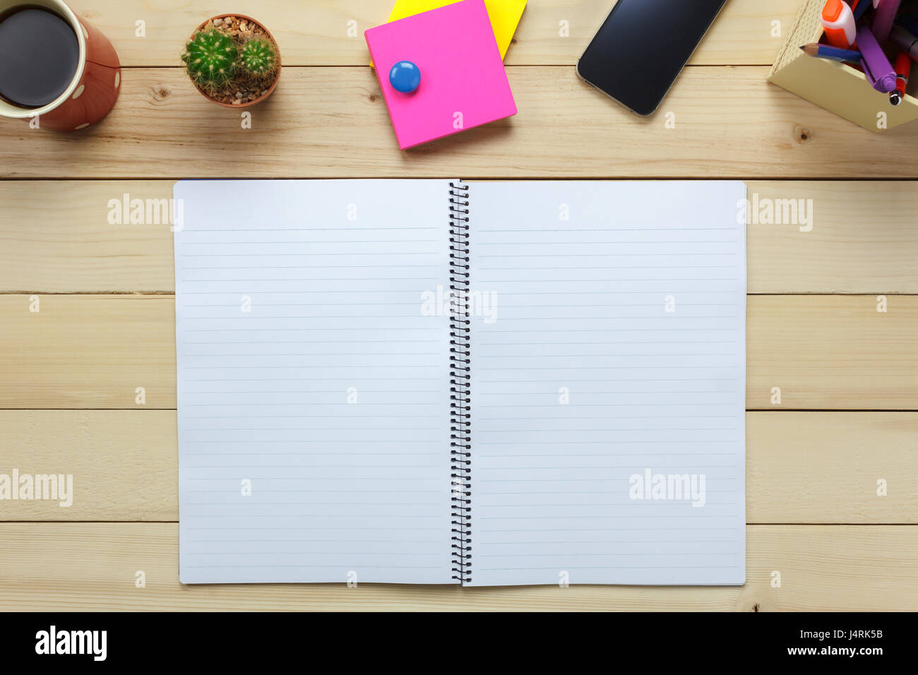 Top view notebook,pencil,black coffee,cactus, watch,note papper ...