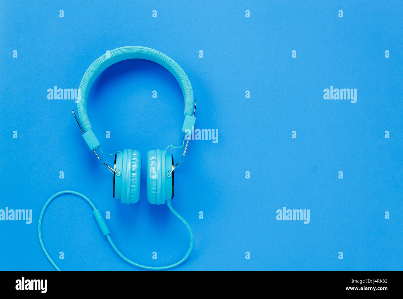 Top view blue headphones on blue background with copy space Stock Photo ...