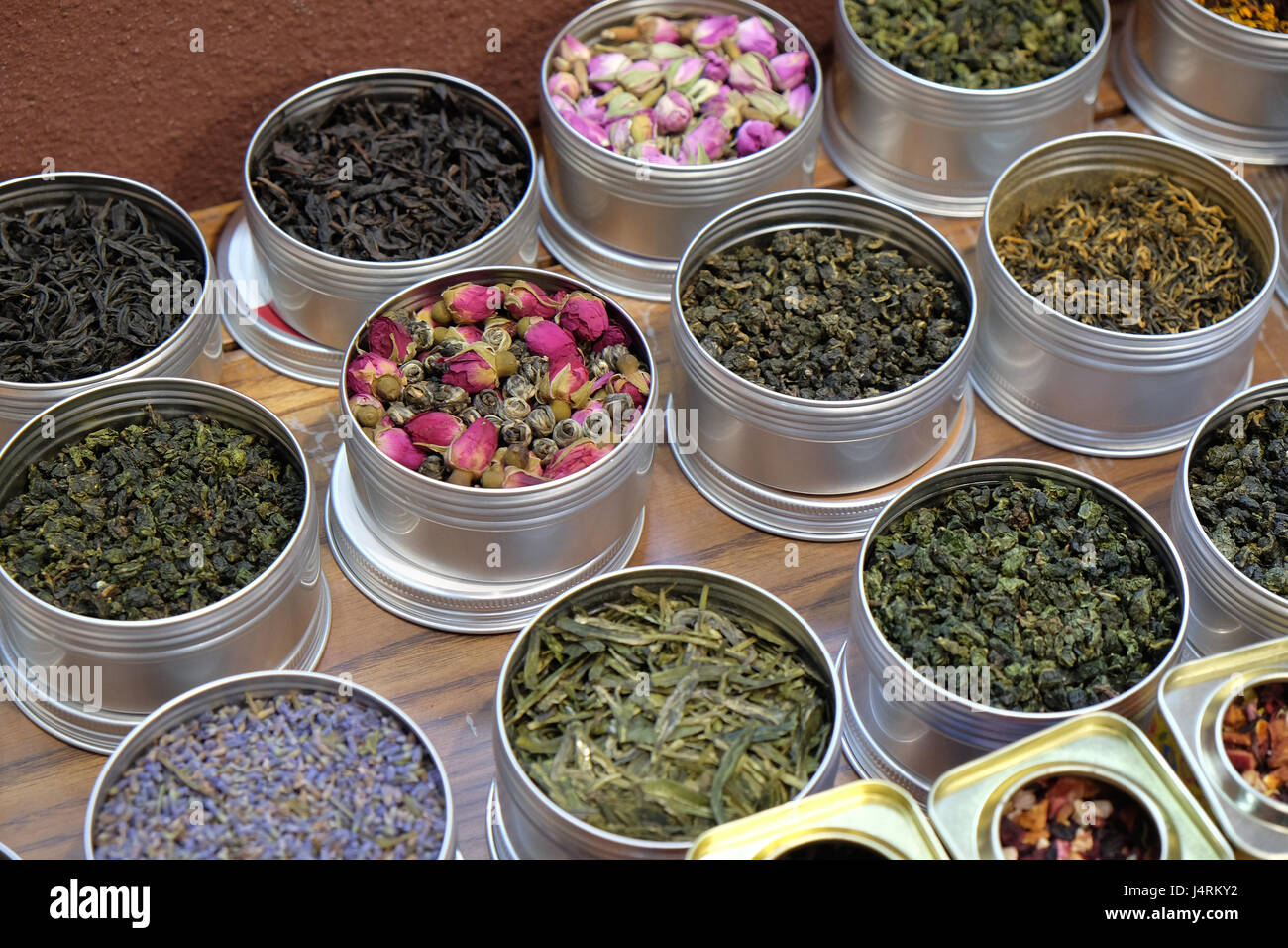 Various types of tea in metal pots exposed for sale in a Chinese tea ...