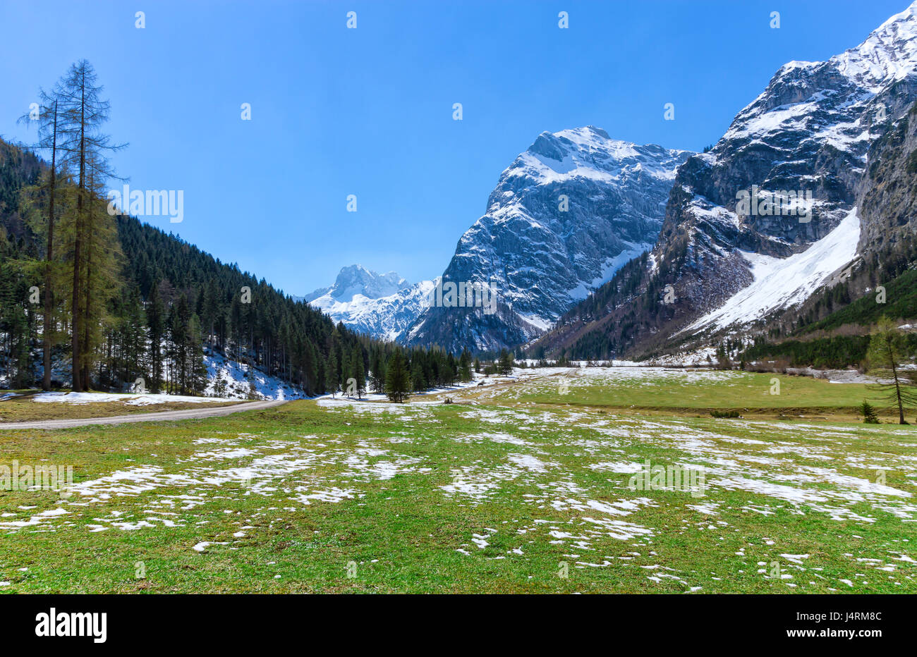 Spring mountain landscape with patches of melting snow. Austria, Tyrol ...