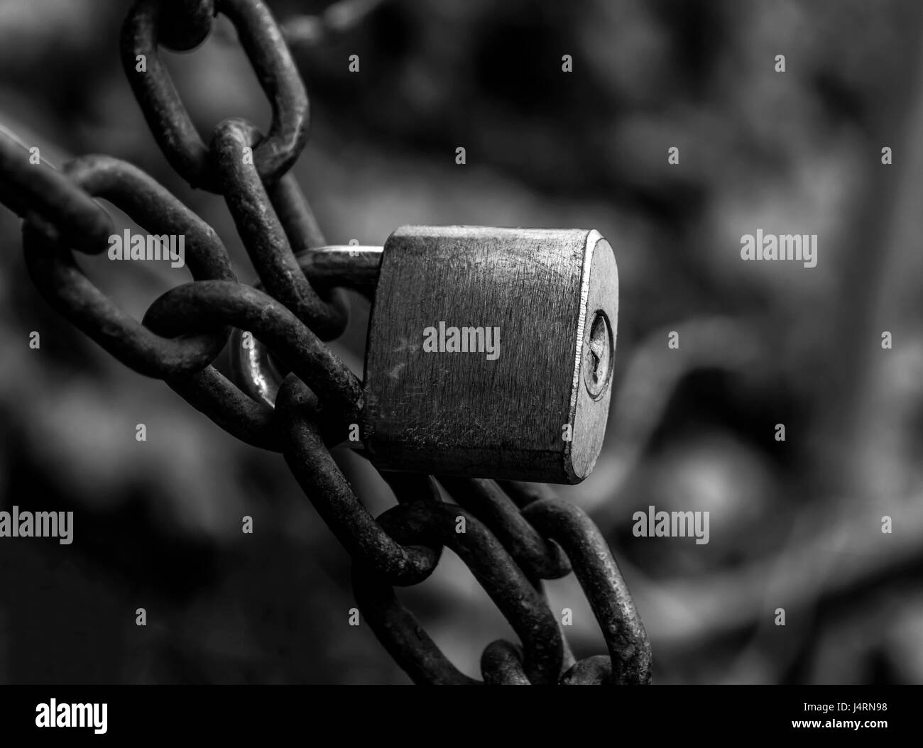 Key lock protecting something with some chains Stock Photo - Alamy