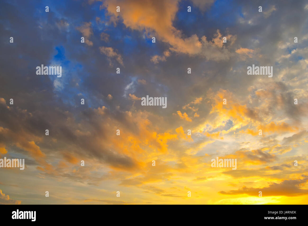 Colorful clouds in bright sunset Stock Photo - Alamy