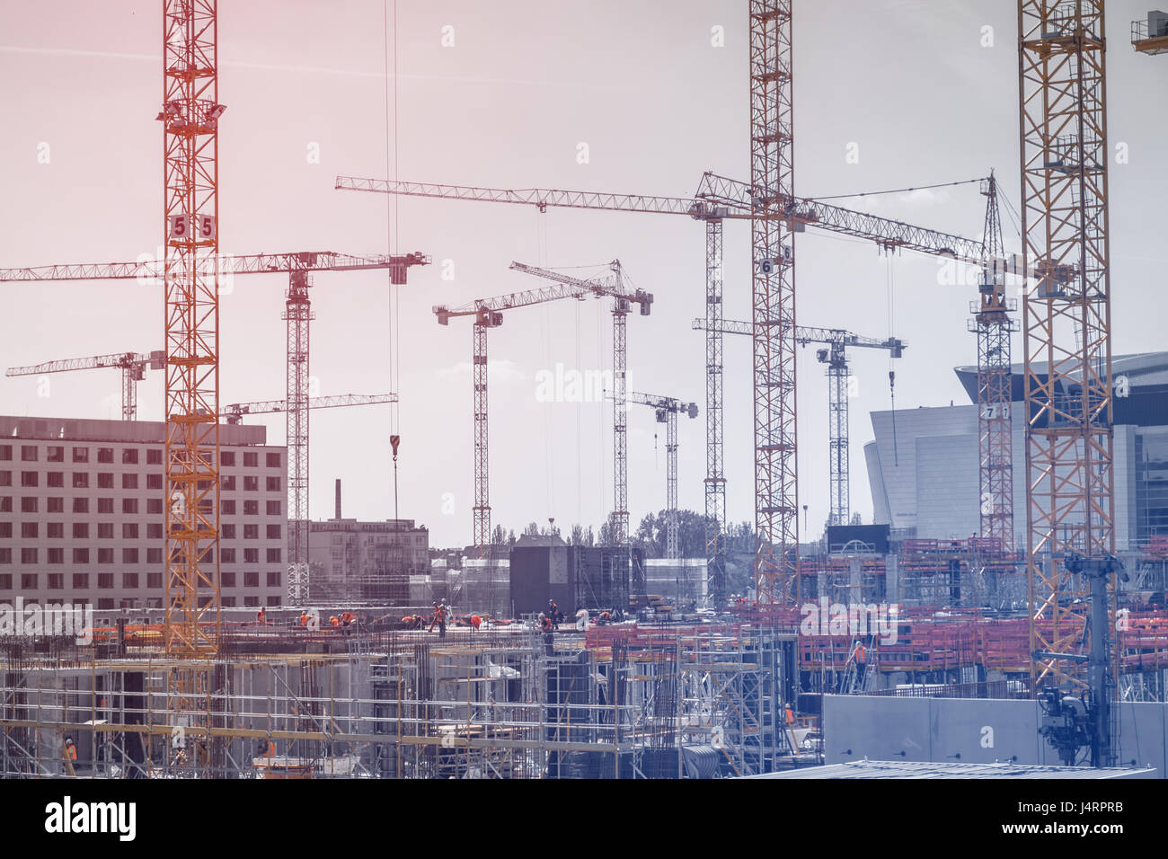 many cranes and construction workers on big construction site Stock ...