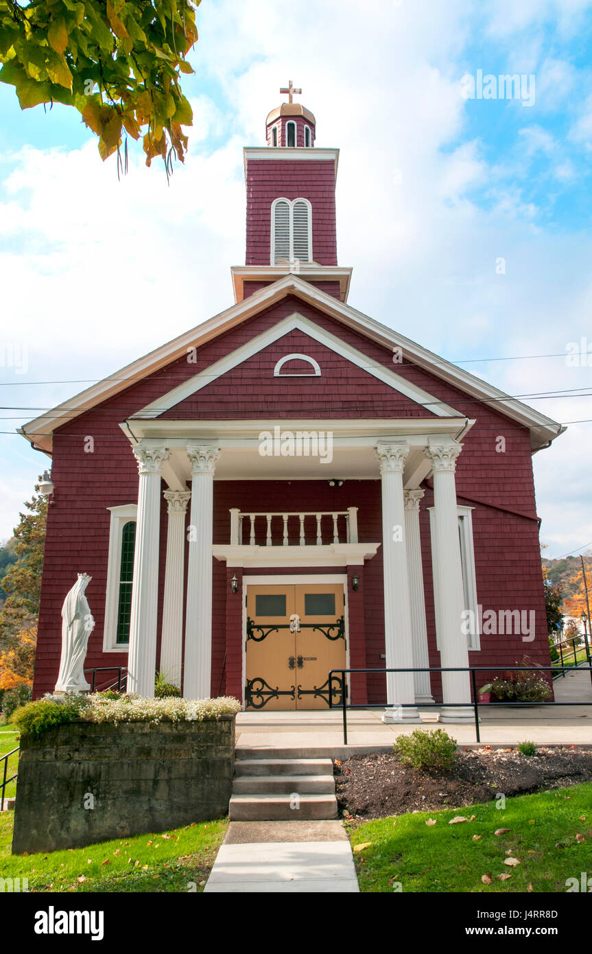 A small Christian country church on a hillside during the fall season ...