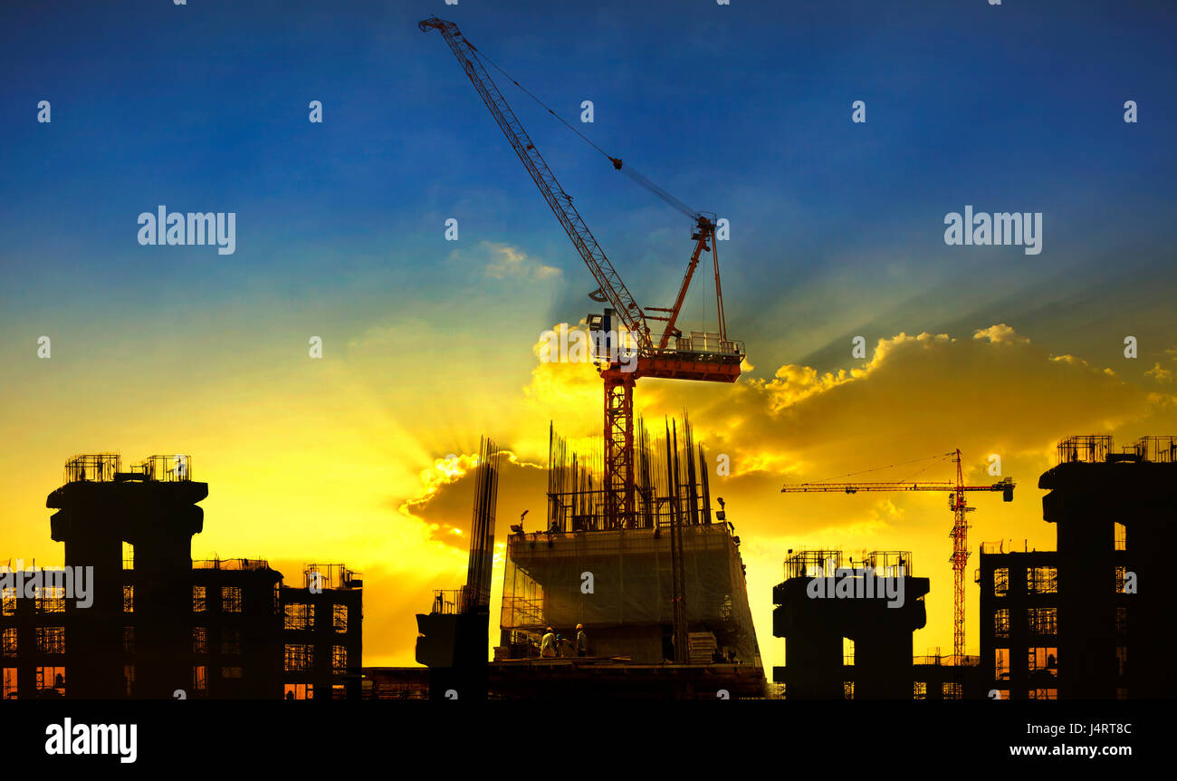 building and crane construction site against beautiful dramatic in ...