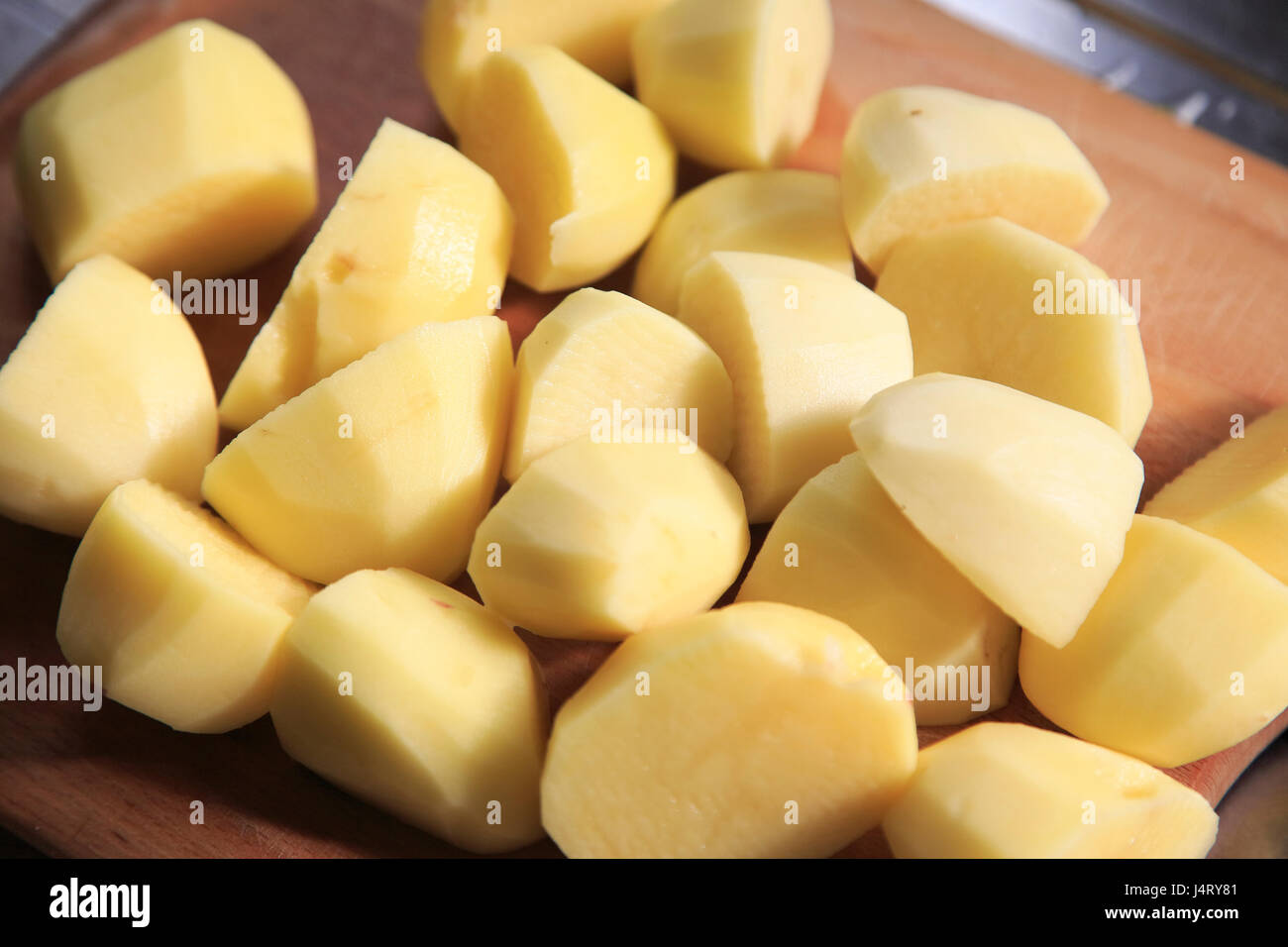 Peeled cut chopped potatoes on chopping board with kitchen knife Stock ...