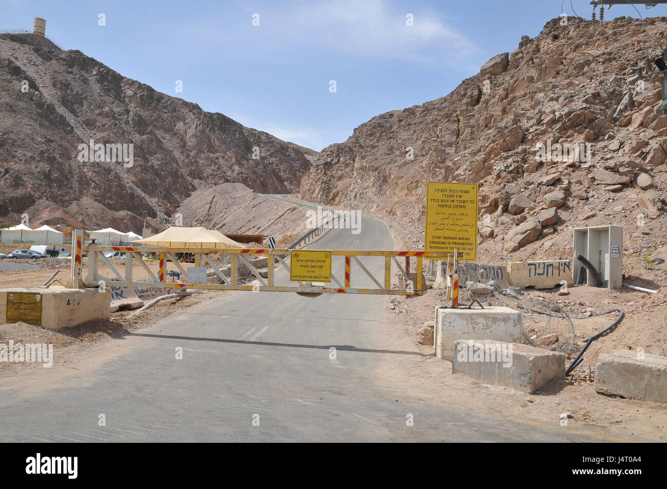 Border ahead warning sign while the road closed by a barrier ...