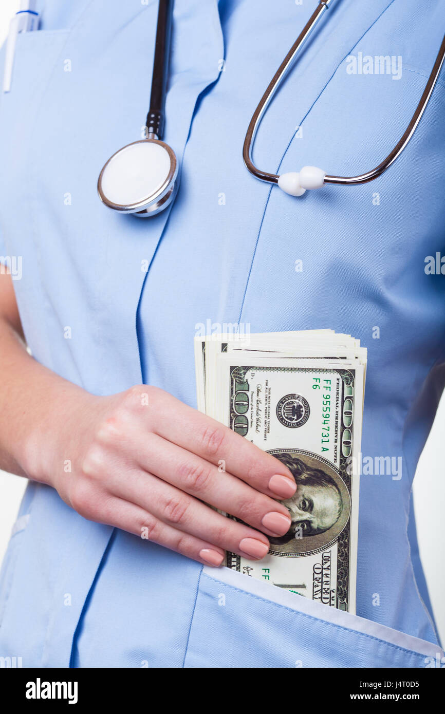 Female doctor with money in his pocket a blue robe Stock Photo - Alamy