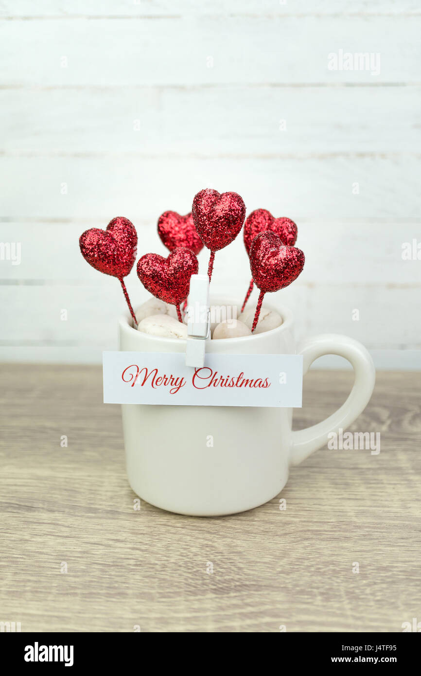 Greeting message on white paper clipped on coffee cup with glitter red ...