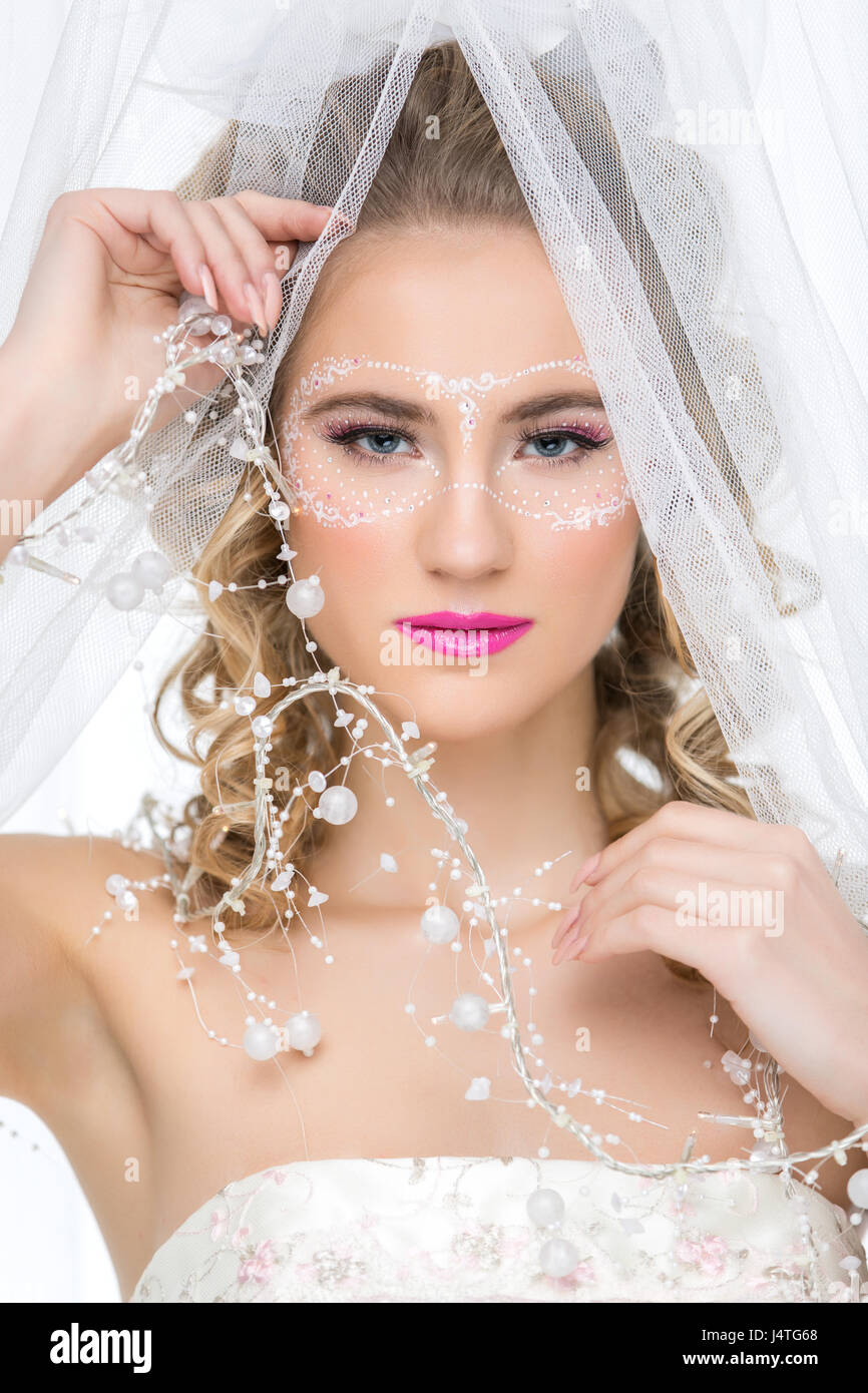 Bride with mask drawn on face Stock Photo - Alamy