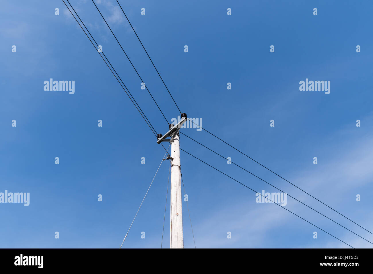 Pole with electric power lines at blue sky Stock Photo - Alamy