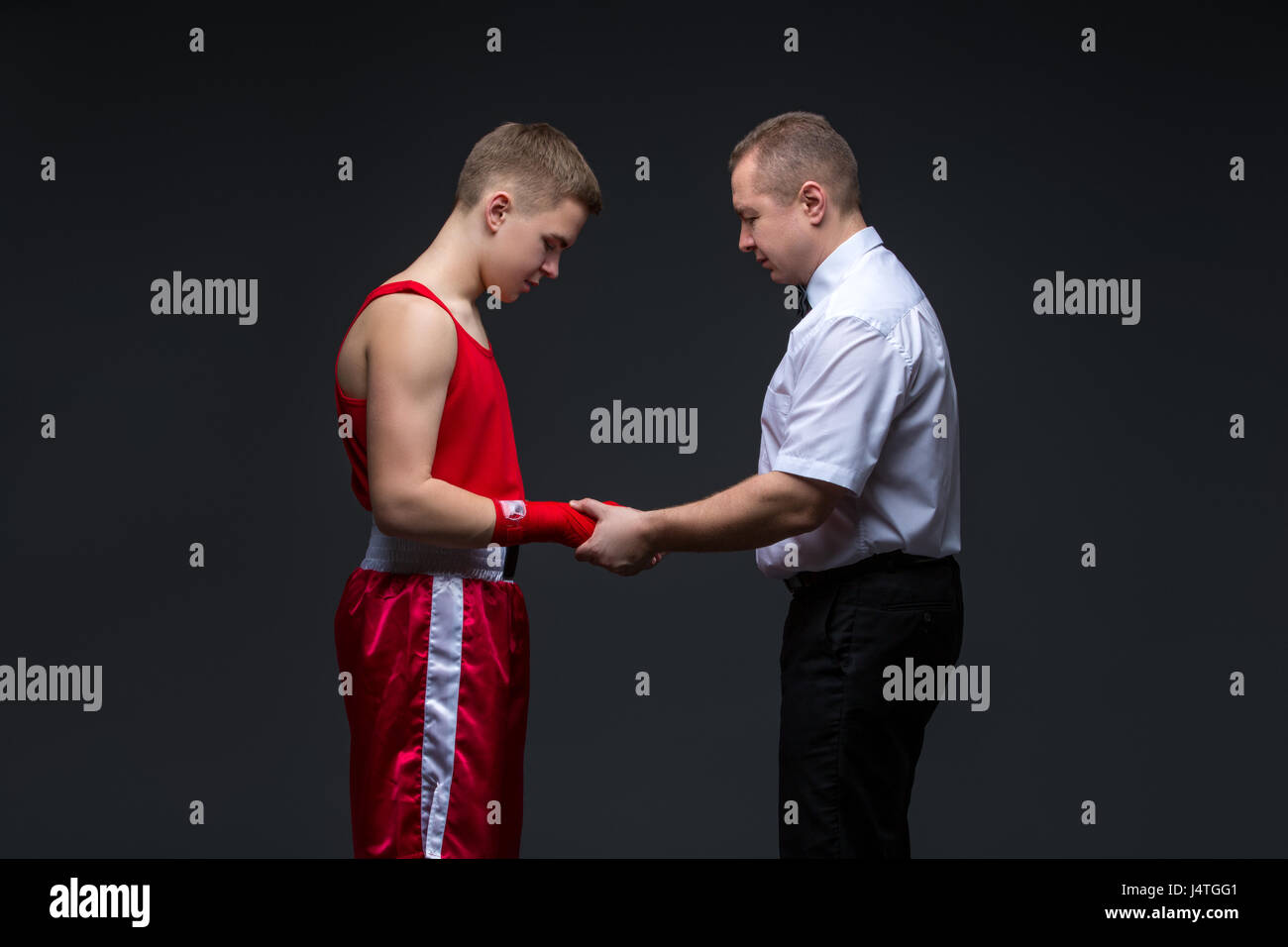 Referee checking young boxer Stock Photo - Alamy