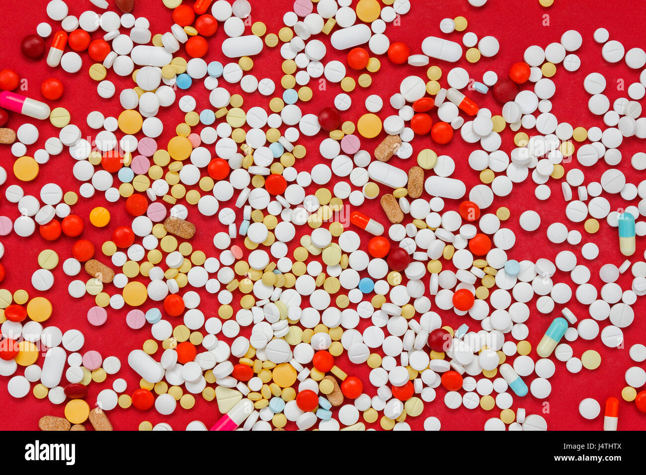 Top view colorful medicine on red background Stock Photo - Alamy