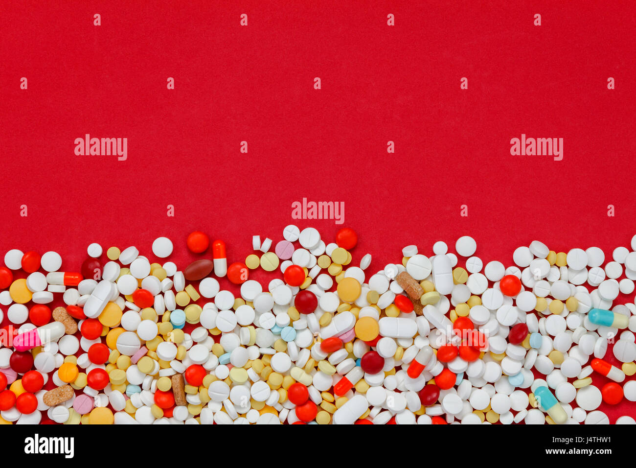 Top view colorful medicine on red background Stock Photo - Alamy