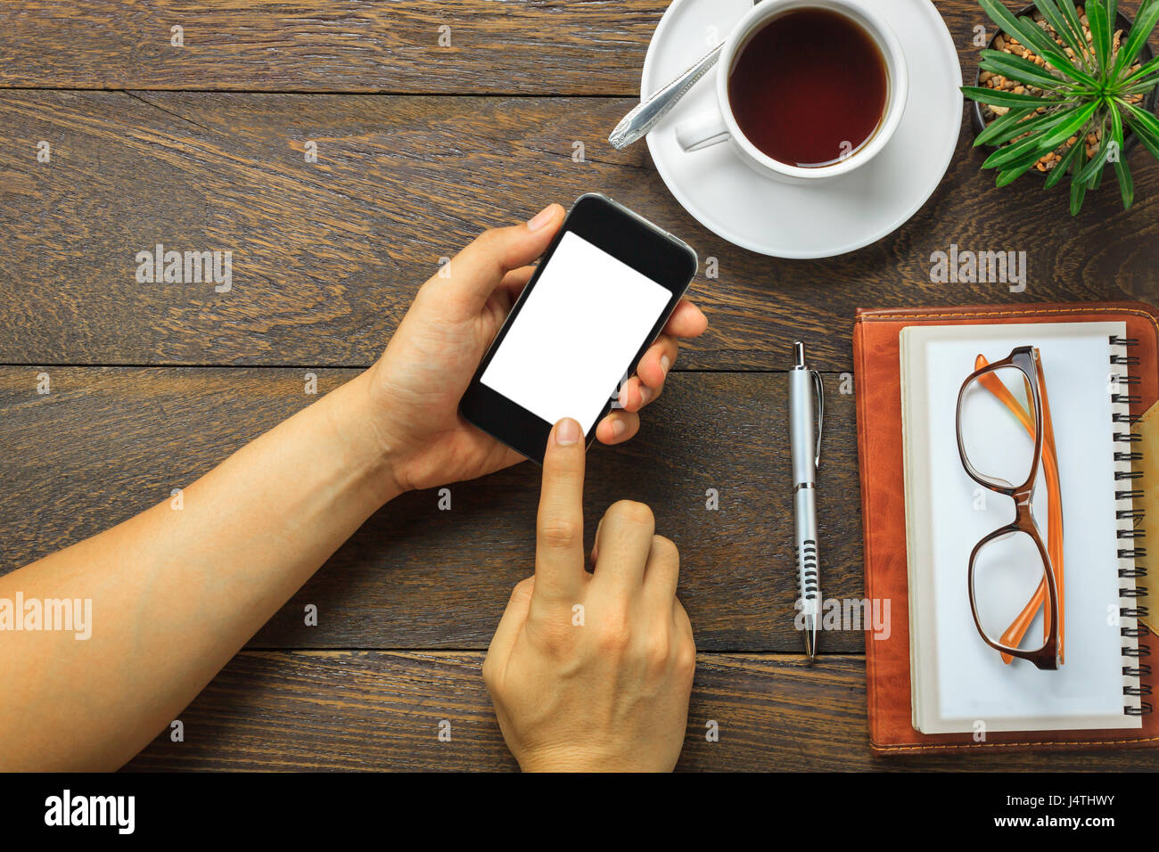 Top view business man using mobile phone and pen,notebook,eyeglasses ...