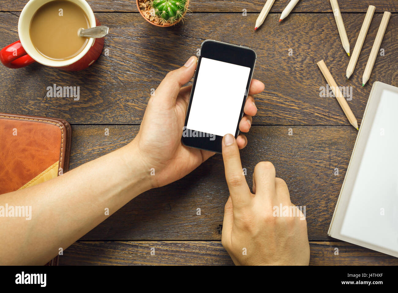 Top view business man using mobile phone and pencil,notebook,cactus on ...