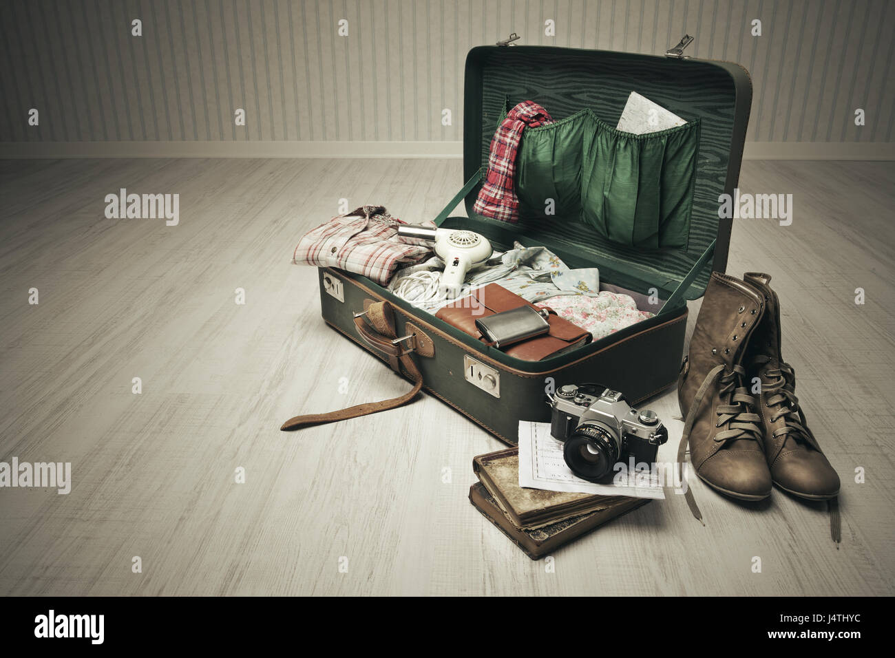 Vintage suitcase open on a wood floor in an empty room Stock Photo - Alamy