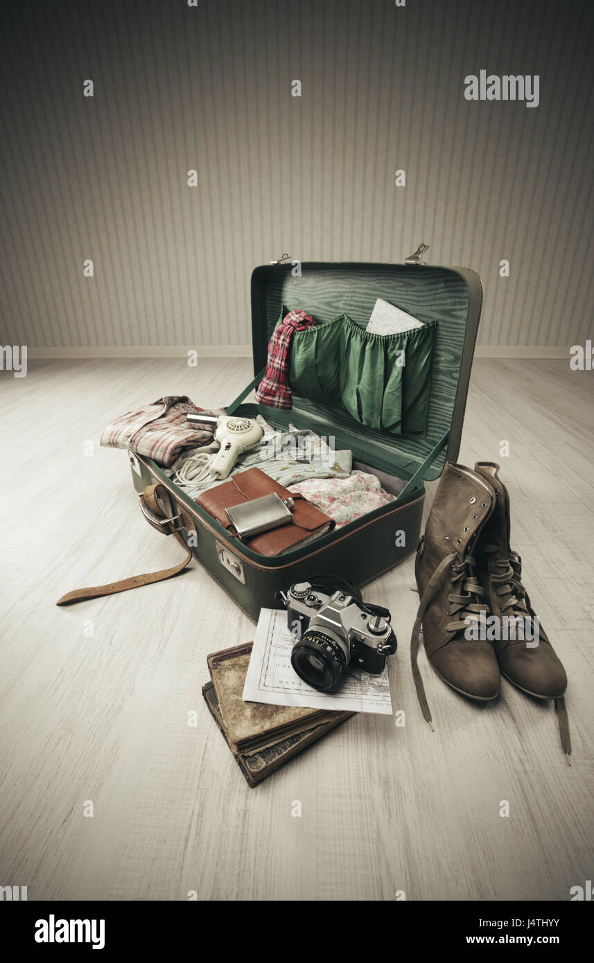 Vintage suitcase open on a wood floor in an empty room Stock Photo - Alamy