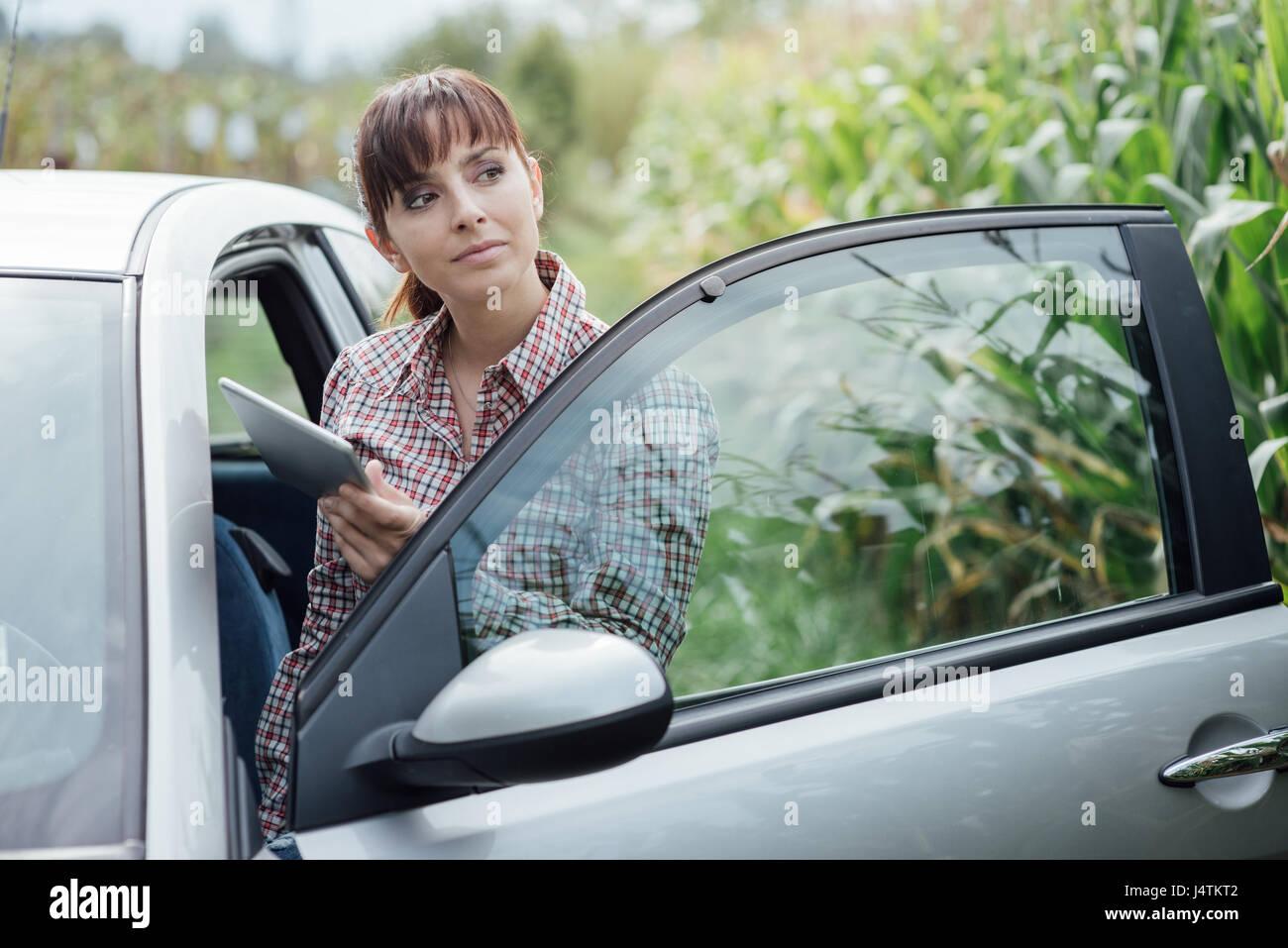 Young sad woman lost in the countryside and looking for directions with ...
