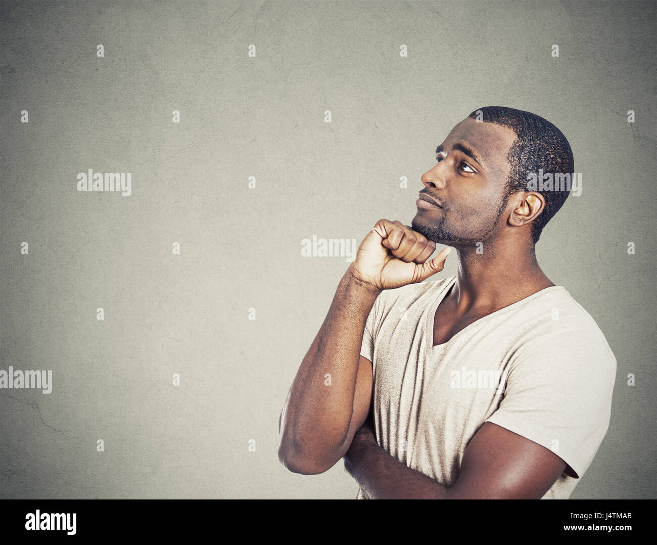 Portrait happy man thinking looking up isolated on grey wall background ...