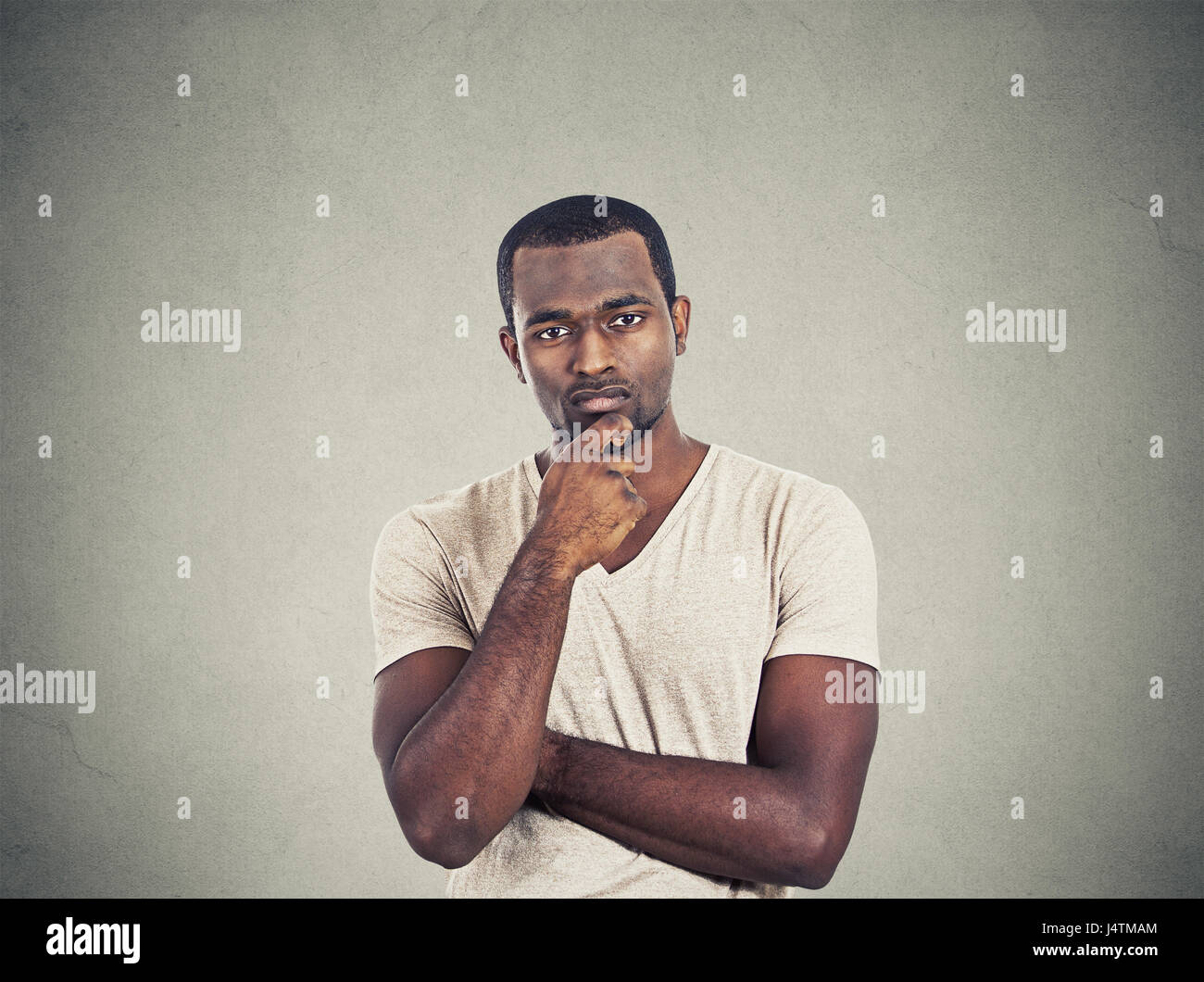Skeptical young man Stock Photo - Alamy