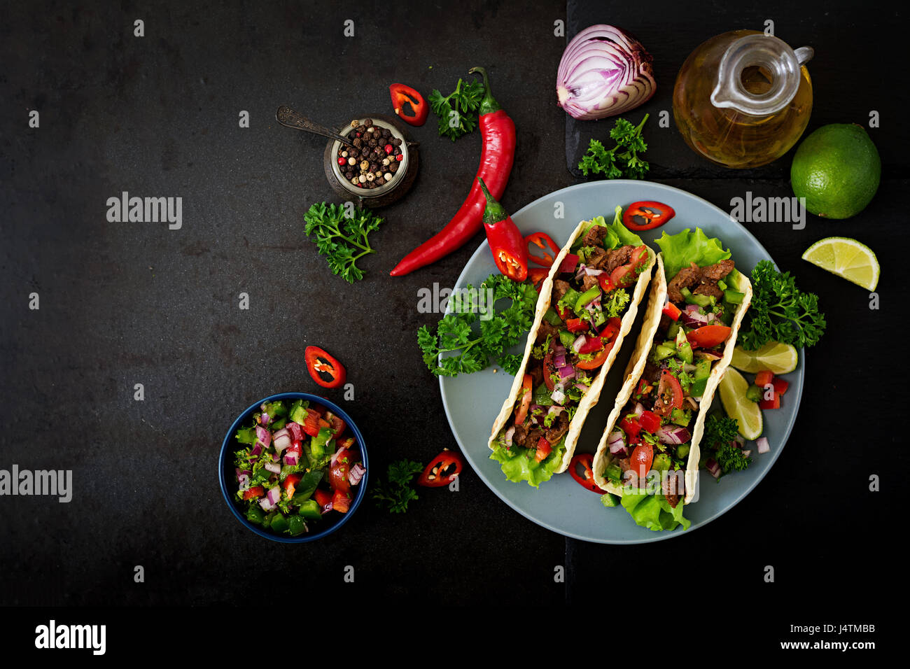 Mexican tacos with beef in tomato sauce and salsa Stock Photo - Alamy