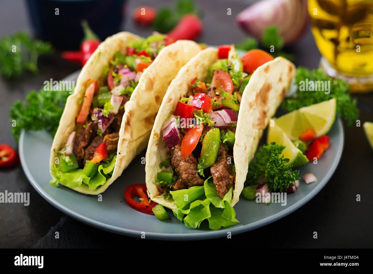 Mexican tacos with beef in tomato sauce and salsa Stock Photo - Alamy