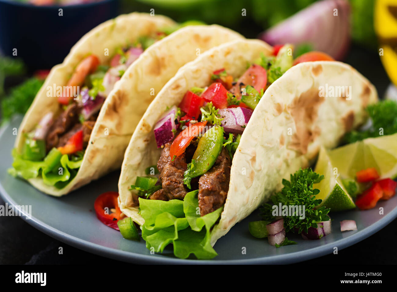 Mexican tacos with beef in tomato sauce and salsa Stock Photo - Alamy