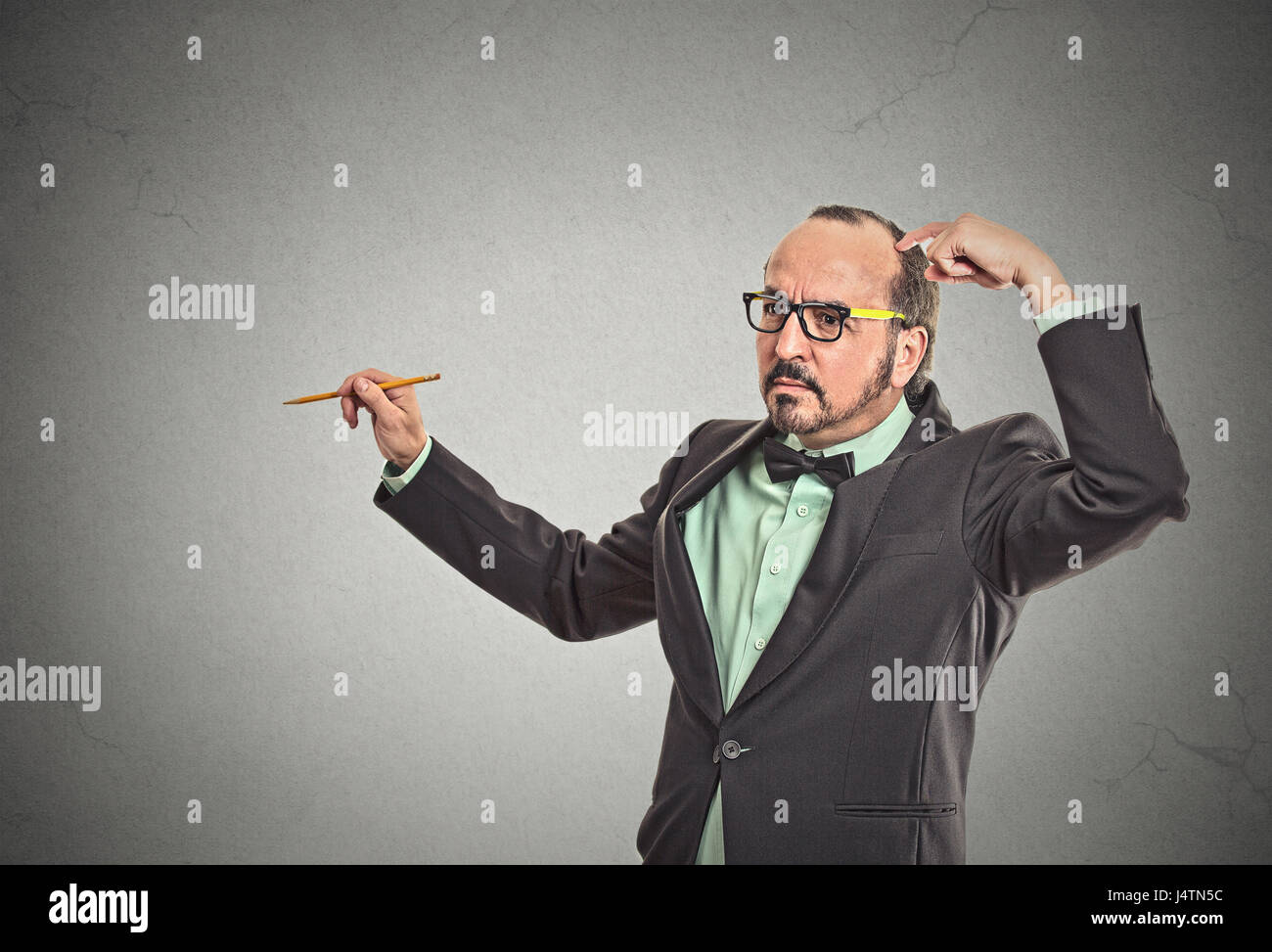 Confused teacher scratching his head thinking what to write on ...