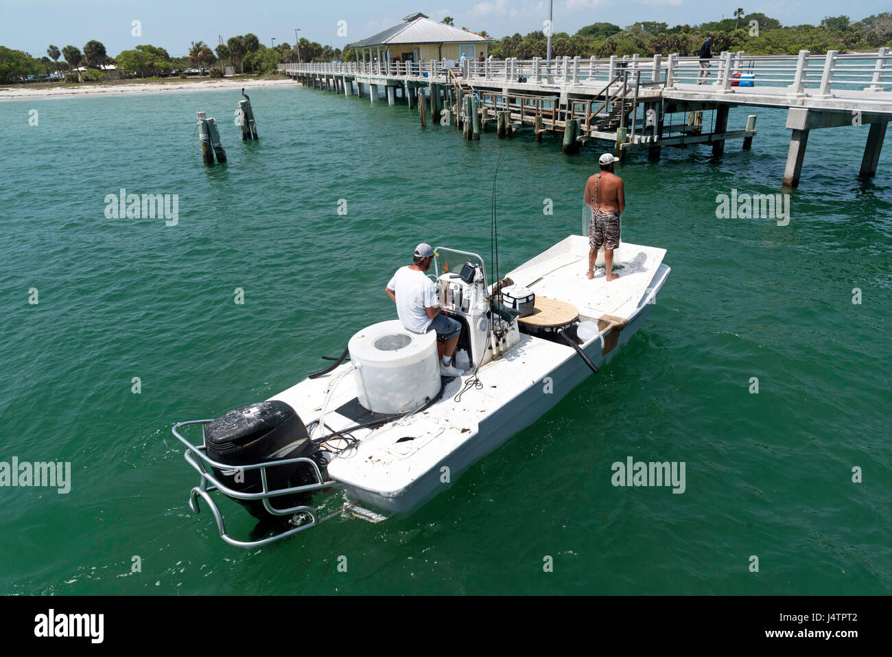 Fishing for bait using a cast net from a small boat on the Gulf of ...