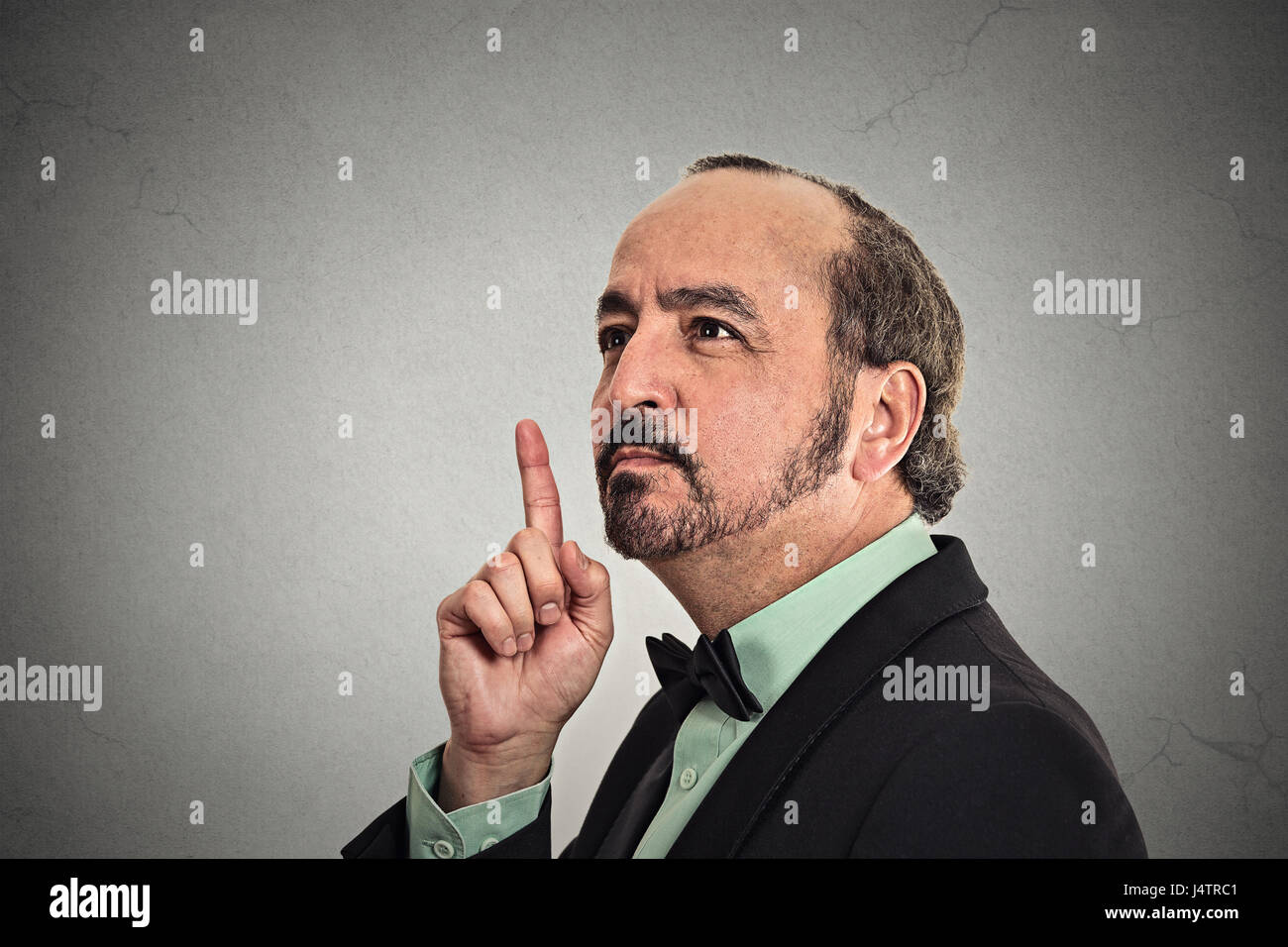 Portrait man thinking dreaming has many ideas looking up isolated grey ...