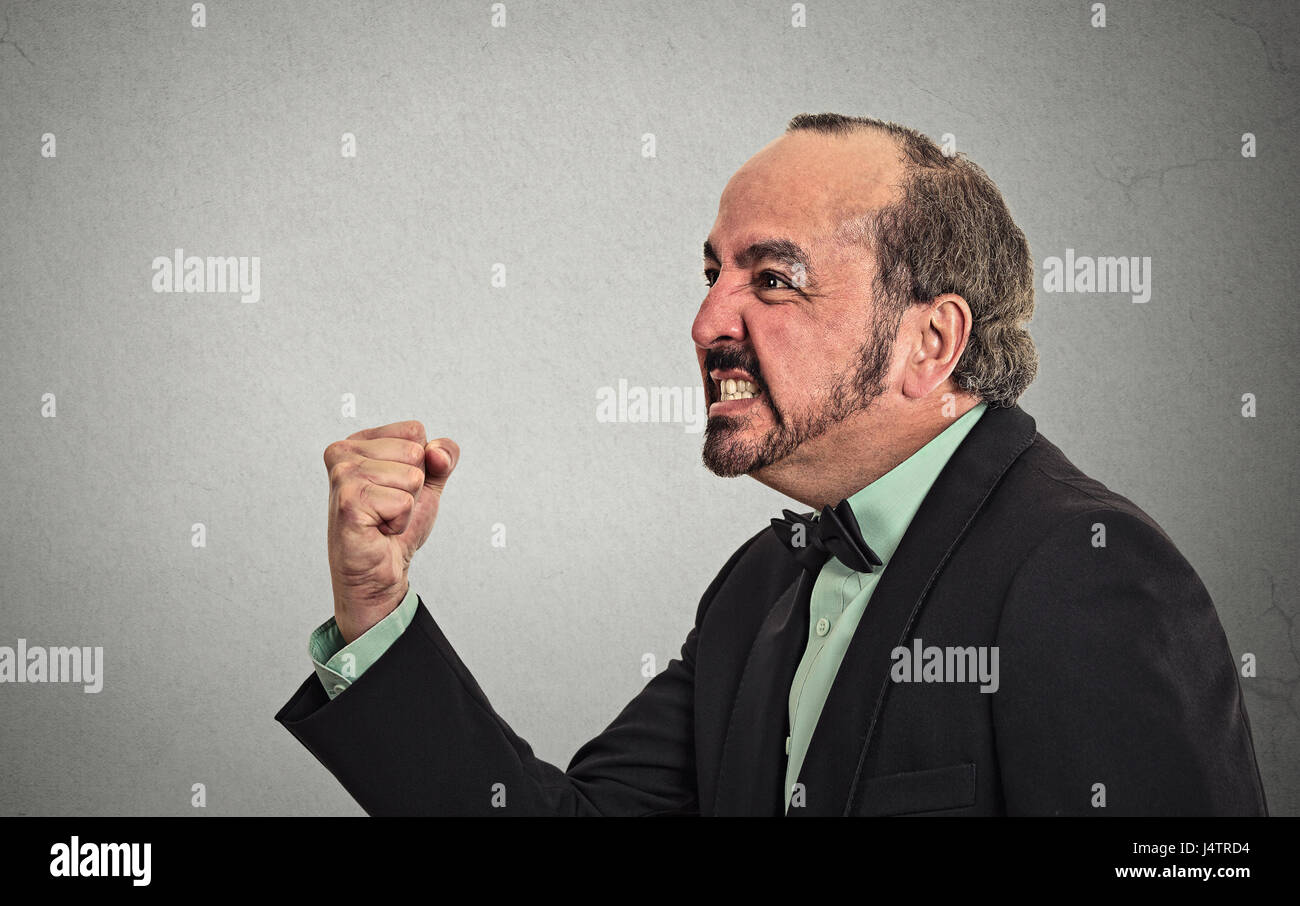 Side profile portrait angry middle aged man isolated on grey wall ...