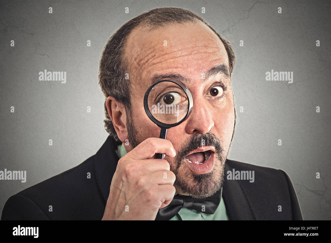 investigator man looking with magnifying glass Stock Photo - Alamy