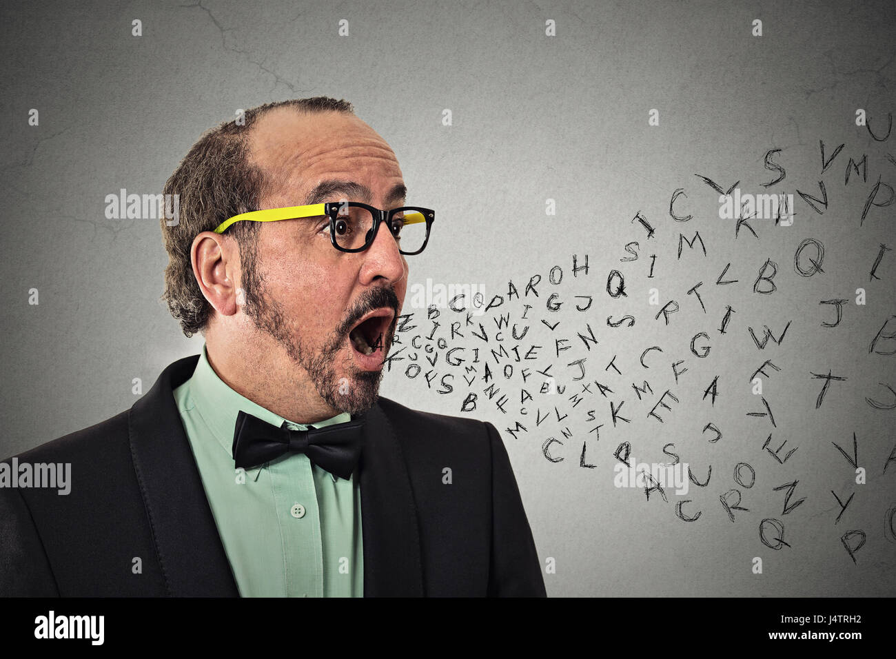 Side view portrait middle aged business man talking with alphabet ...