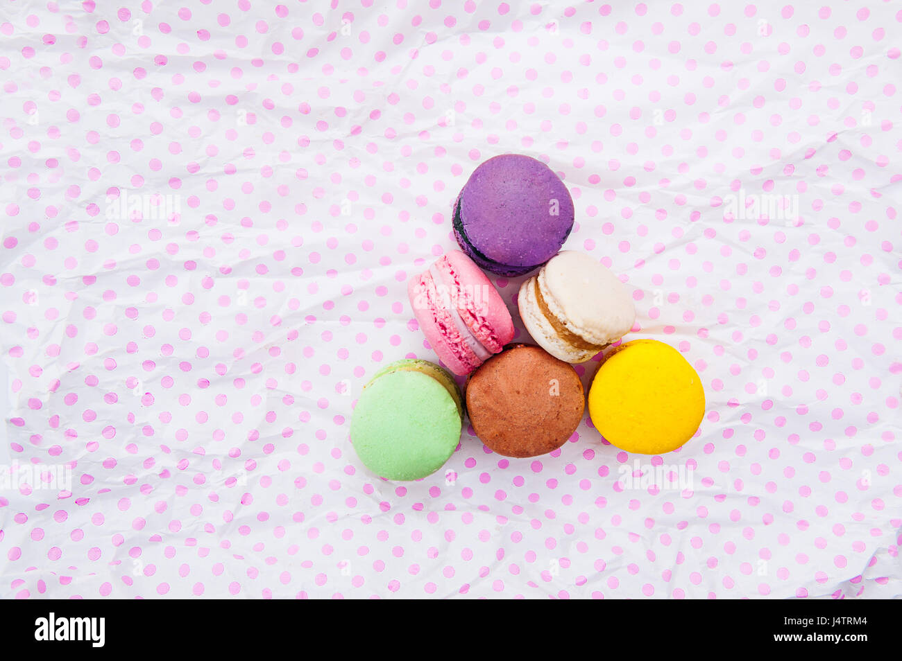 Multicolored cake macaron or macaroon in the triangle form on the white ...