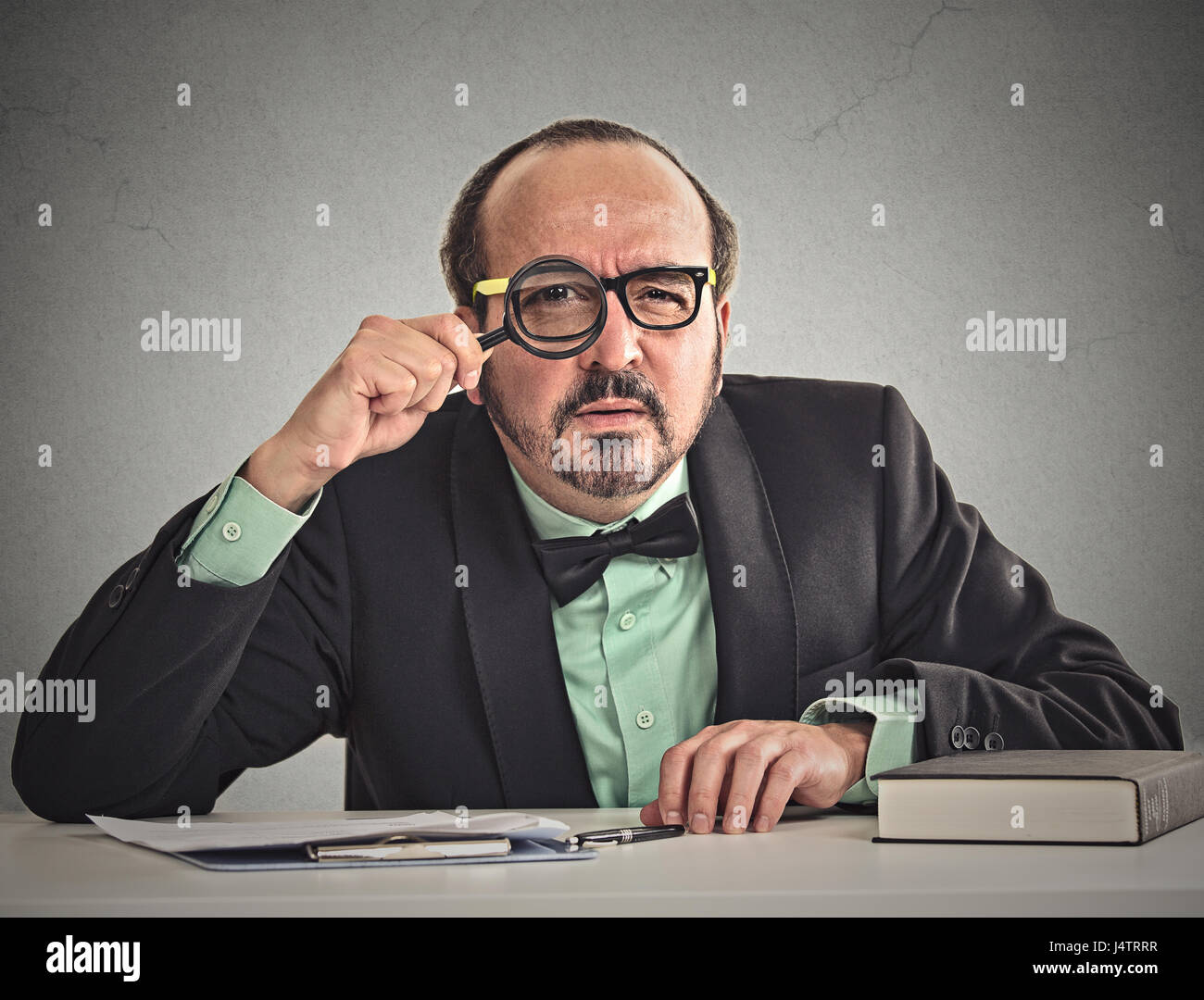 Curious corporate businessman skeptically looking at you through ...