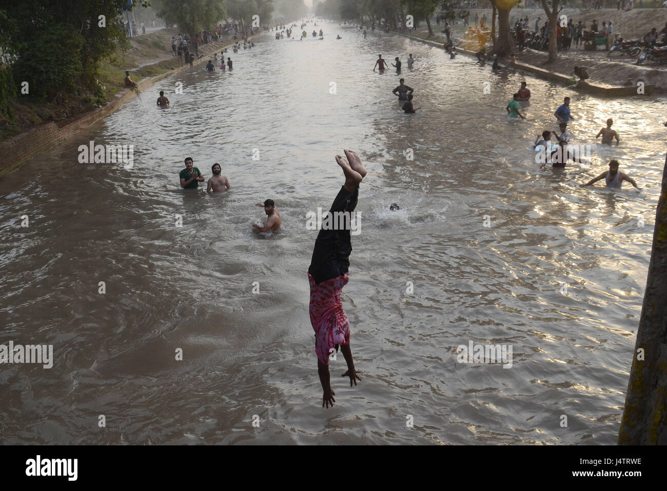 Lahore, Pakistan. 15th May, 2017. Pakistani people jumping dip in canal ...